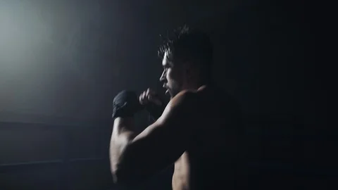 Male boxer training in the dark ring. Sl... | Stock Video | Pond5
