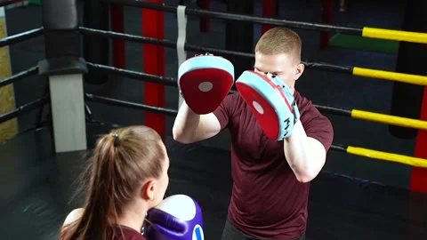 Male boxing instructor using boxing kick... | Stock Video | Pond5