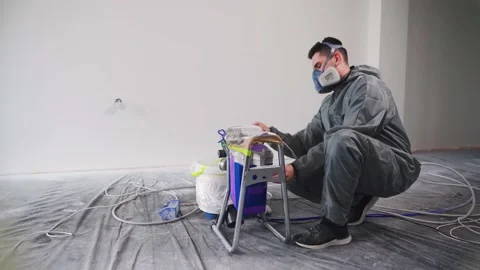 Male builder painter setting up machine ... | Stock Video | Pond5