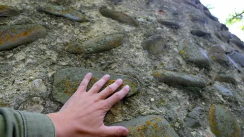 Male cameraman's hand slides on stone wa... | Stock Video | Pond5