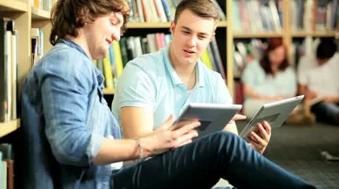 Male classmates social networking on tab... | Stock Video | Pond5