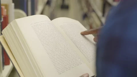 Male College Student Perusing the Pages ... | Stock Video | Pond5