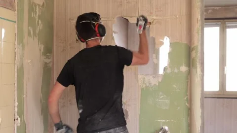 male contractor punching a hole in wall ... | Stock Video | Pond5