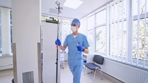 Male doctor coming into the ward with a ... | Stock Video | Pond5