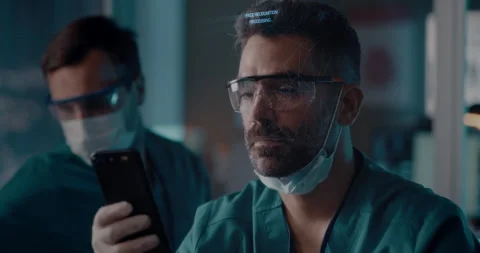 Male doctor unlocking smartphone with fa... | Stock Video | Pond5