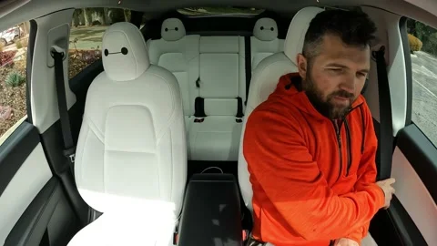 Male driver 40s getting into Tesla Model... | Stock Video | Pond5