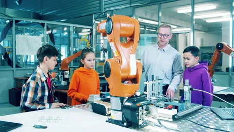 Male engineer and children are watching ... | Stock Video | Pond5