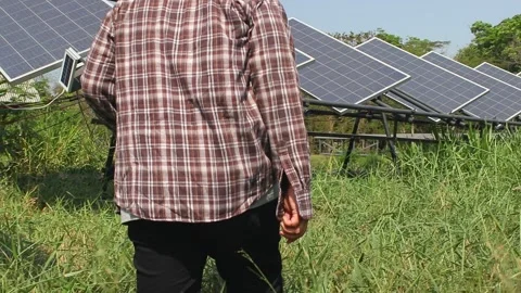 A male farmer always checks the solar pa... | Stock Video | Pond5