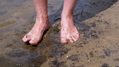 Male Feet are Splashing in Mud, Dirty Wa... | Stock Video | Pond5