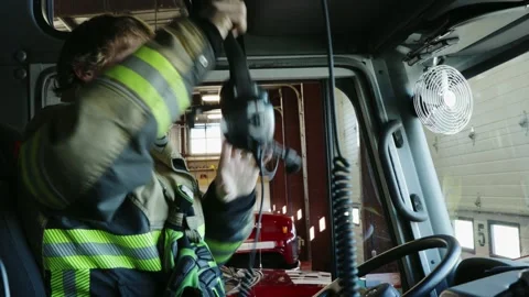 Male firefighter getting into fire engin... | Stock Video | Pond5