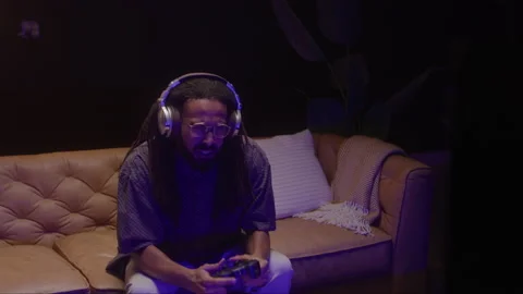 Male Gamer with Dreadlocks and Headphone... | Stock Video | Pond5