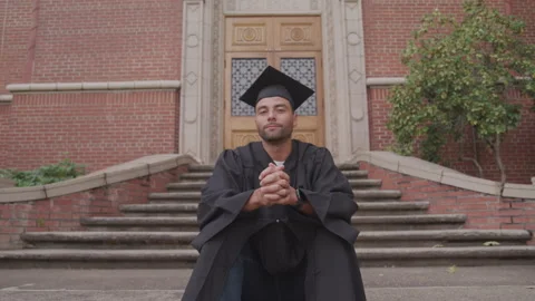 Male Graduate Sitting on the Steps of a ... | Stock Video | Pond5