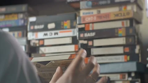 male hand in a blue polo takes a VHS tap... | Stock Video | Pond5