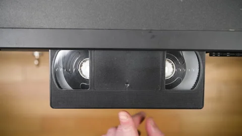 Male hand inserting VHS tape into VCR vi... | Stock Video | Pond5