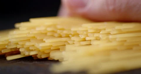 Male hand mixes spaghetti dry pasta in t... | Stock Video | Pond5