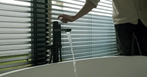 Male hand turn on water and fill bathtub... | Stock Video | Pond5