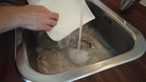 Male hand washing a plate in a washbasin | Stock Video | Pond5