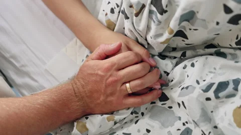 Male hand with a wedding ring covering t... | Stock Video | Pond5