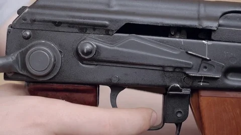 Male hands holding a machine gun. Switch... | Stock Video | Pond5