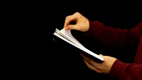 Male Hands Skip Pages Of a Book Over Bla... | Stock Video | Pond5