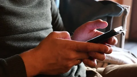 Male hands tapping and swiping his smart... | Stock Video | Pond5