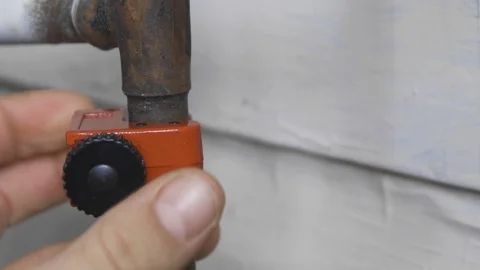 Male hands turn an orange pipe cutter to... | Stock Video | Pond5