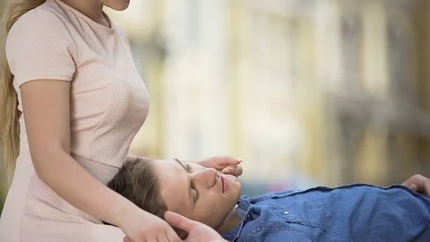 Male holding head on girls lap, girlfrie... | Stock Video | Pond5