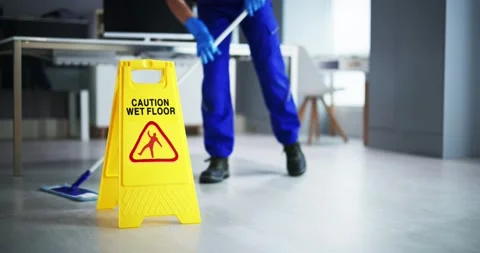 Male Janitor Cleaning Floor With Caution... | Stock Video | Pond5