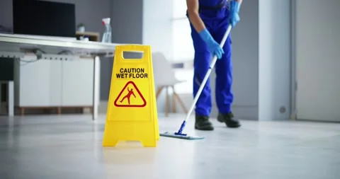 Male Janitor Cleaning Floor With Caution... | Stock Video | Pond5