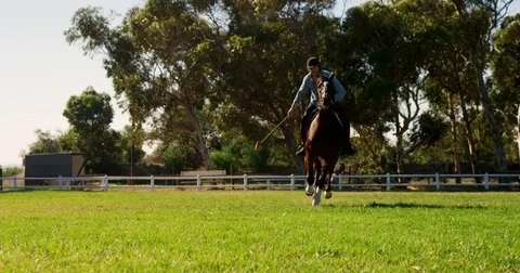 Male jockey riding horse in the ranch 4k | Stock Video | Pond5