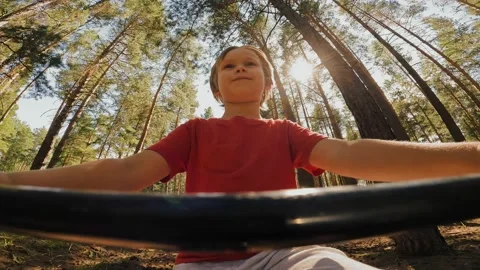 Male kid riding on speed bike at natural... | Stock Video | Pond5