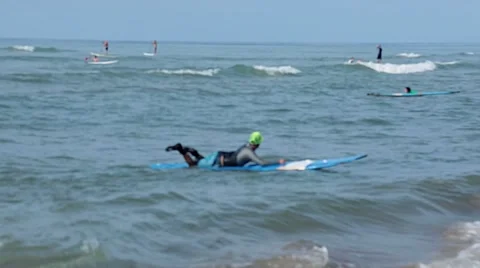 Male laying on surf board, ocean waves | Stock Video | Pond5