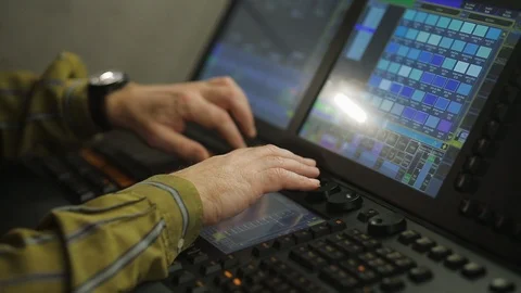 A male lighting director at the console ... | Stock Video | Pond5