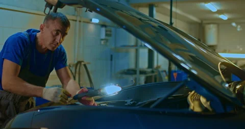 Male mechanic in mechanics garage, check... | Stock Video | Pond5