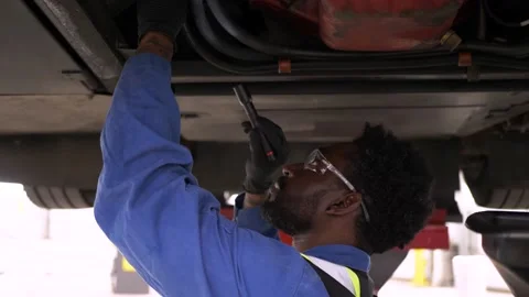 Male mechanic working under bus in maint... | Stock Video | Pond5