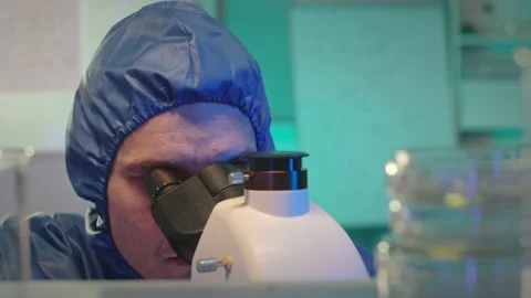 Male Microbiologist Using Microscope in ... | Stock Video | Pond5