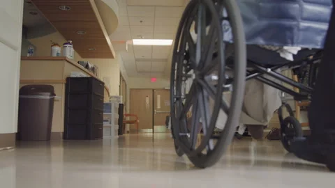 Male Nurse Wheels an Elderly Patient Dow... | Stock Video | Pond5