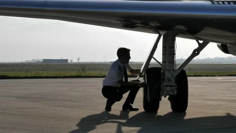 Male Pilot Checking the Landing Gear of ... | Stock Video | Pond5