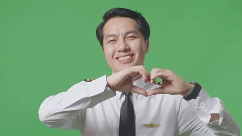 Male Pilot Making Heart Gesture And Smil... | Stock Video | Pond5
