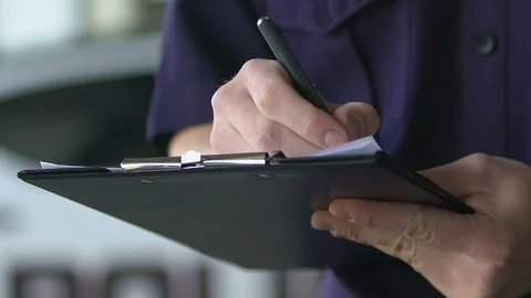 Male police officer completing documents... | Stock Video | Pond5