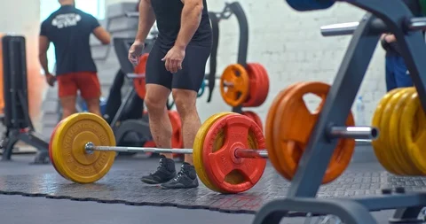 Male powerlifter lifts a barbell with a ... | Stock Video | Pond5
