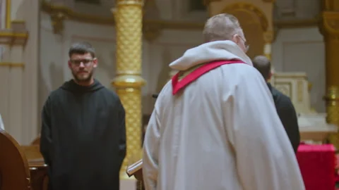Male Priests in Black Robes Walks Toward... | Stock Video | Pond5