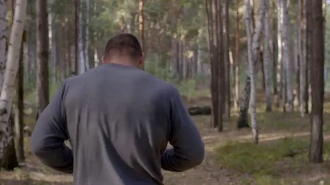 Male runner running on road through fore... | Stock Video | Pond5