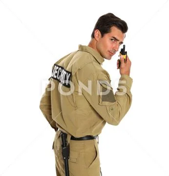 Male security guard in uniform using portable radio transmitter on ...