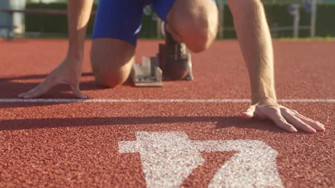 Male sprinter, hands on the line and leg... | Stock Video | Pond5