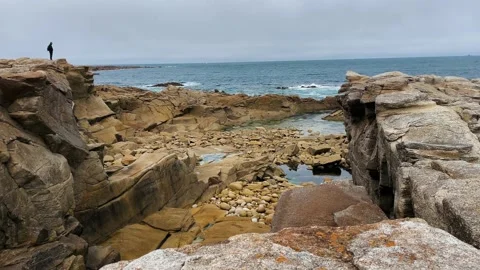 Male Tourist standing on cliff watching ... | Stock Video | Pond5