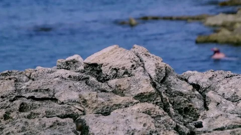 Maltese rock landscape with diver on bac... | Stock Video | Pond5