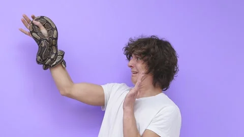 a man is afraid of a snake that has wrap... | Stock Video | Pond5