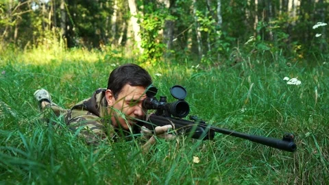 man aiming with a sniper rifle lying on ... | Stock Video | Pond5