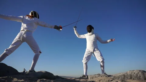 A man and woman fencing on the beach. | Stock Video | Pond5